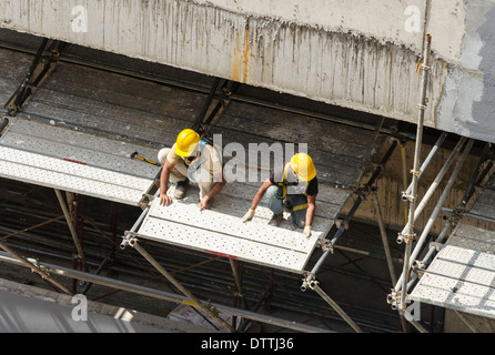 Construction workers fixing scaffolding on a building in Kuala Lumpur ...
