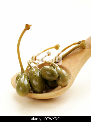 green capers in wooden spoon on wooden background close-up Stock Photo ...