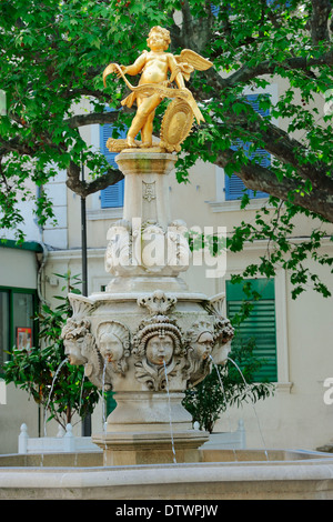 A vertical shot of a fountain with a statue on an old market square in ...