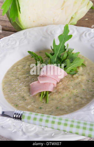 Creamy potato soup with bacon pieces, shredded cheddar cheese and ...