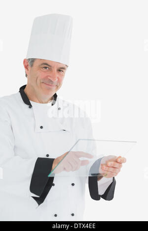 Happy chef using tablet pc while cooking Stock Photo - Alamy