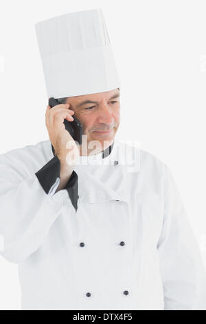 Male chef using cell phone against white background Stock Photo - Alamy