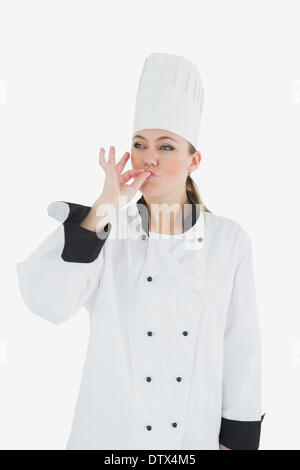 Female chef kissing her fingers Stock Photo - Alamy