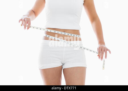 Midsection of a woman measuring her body Stock Photo - Alamy