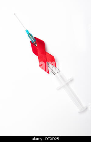 Red ribbon wrapped around syringe Stock Photo - Alamy