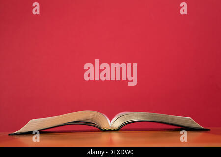 Open book lying on the table in the public library Stock Photo - Alamy