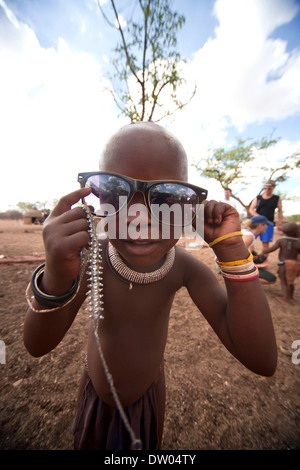 A young boy from indigenous Himba people tribe in traditional clothes ...