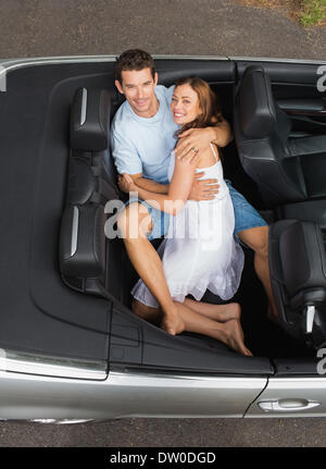 Couple hugging in the back seat Stock Photo - Alamy