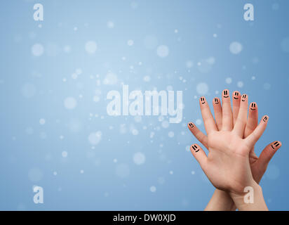 Happy finger smileys with empty blue bokeh background Stock Photo - Alamy