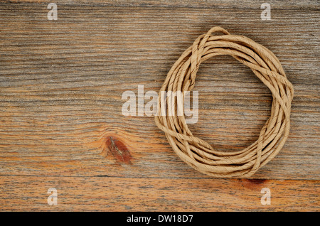 oval hank of packthread over wooden texture Stock Photo - Alamy