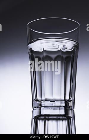 Simple water-glass with light surface Stock Photo - Alamy
