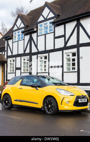 Yellow Citroen DS3 hatchback parked in front of a timber-framed cottage ...