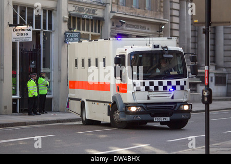 Armed City of London Police convoy escorts a prison van as it arrives ...