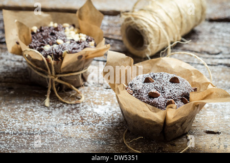 Closeup of decorating chocolate muffins with string Stock Photo - Alamy
