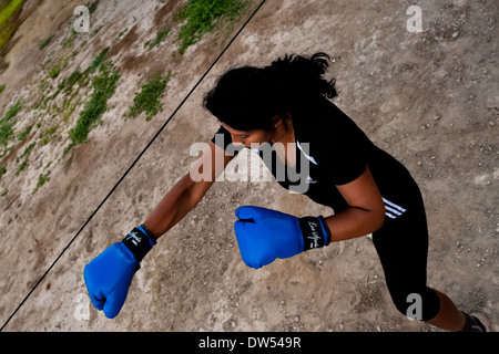 A Peruvian woman practices punching and movement while training in the ...