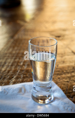 Single shot of Tequila on wood table Stock Photo - Alamy