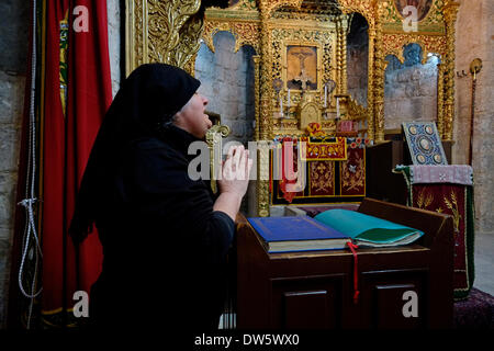 A Syriac Orthodox worshiper praying inside San Marcos or Saint Mark ...
