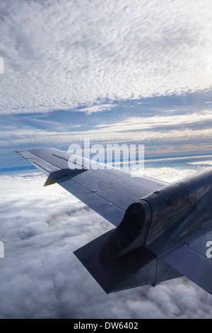 Flying over the clouds. Airplane wing with blue sky and copy space ...