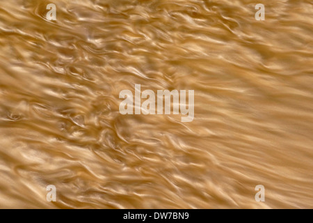 Patterns of swirling sediment in a mud puddle on the Annapurna road ...