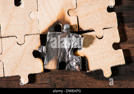 Burning wooden puzzle on dark background Stock Photo - Alamy