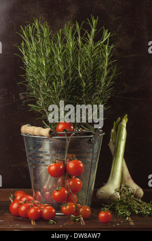Ripe cherry tomatoes on a branch on a wooden background. Growing ...