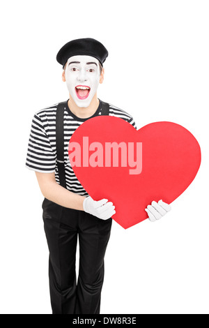 Mime holding red heart isolated on white background Stock Photo - Alamy