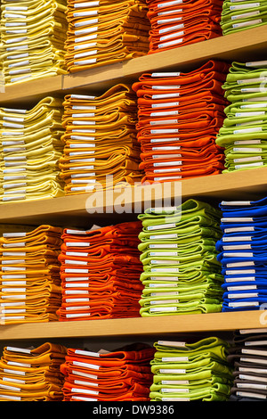 Neat stacks of folded clothing on the shop shelves. Color folding shirt ...