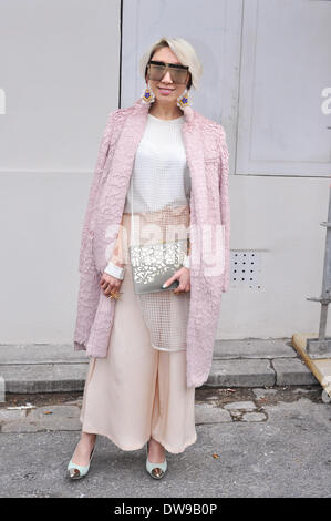 A chic showgoer arriving at the Dior runway show during Paris Fashion Week - Feb 28, 2014 ...