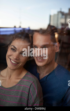 Smiling couple behind window pane Stock Photo - Alamy