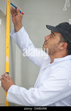 builder marking the wall Stock Photo - Alamy