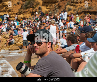 Spectators on beach watching surfing event Stock Photo - Alamy