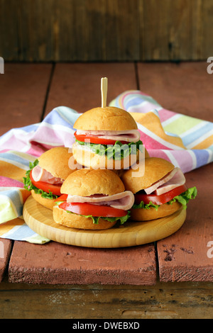 Burger mini burgers snacks on a wooden table with craft paper ...