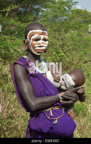 Surma woman with body paintings and holding her baby, Kibish, Omo River ...