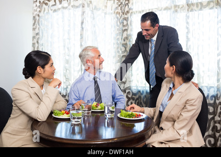 Business colleagues having meal together Stock Photo - Alamy