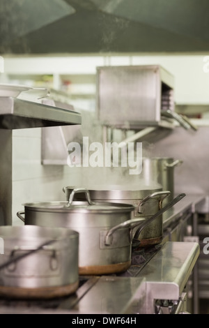 Large steaming pots on the stove in a commercial kitchen Stock Photo ...