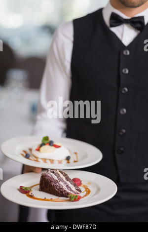 Waiter showing a dish Stock Photo - Alamy