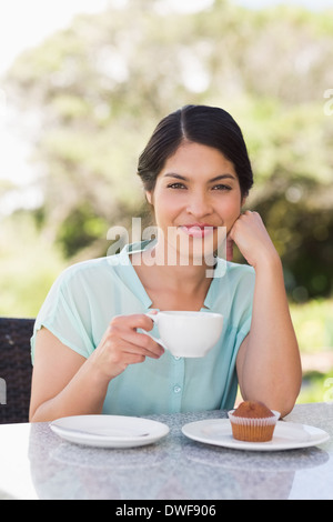 Portrait of a smiling female having coffee at coffee shop Stock Photo ...