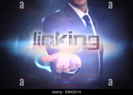 Businessman presenting the word linking against glowing blue pattern on ...