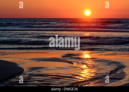 Sunset over the sea. Reflection of sunlight in the sea waves. Red sky ...
