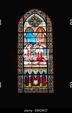 A vertical shot of a stained-glass window in Saint Vitus Cathedral ...