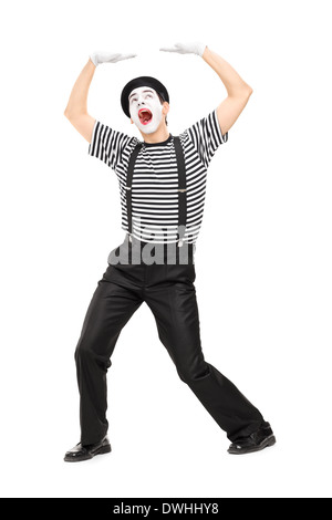 Mime artist simulate carrying something over his head Stock Photo - Alamy