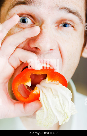 Young man with red pepper. humor Stock Photo - Alamy