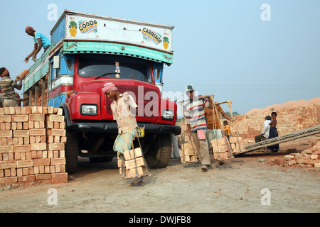 Brick field workers carrying complete finish brick from the kiln in ...