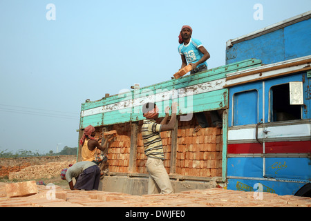 Brick field workers carrying complete finish brick from the kiln, and ...