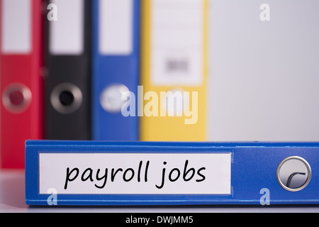 Payroll jobs on blue business binder Stock Photo - Alamy