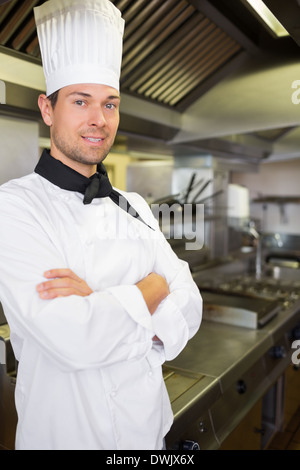 Smiling male cook with arms crossed in kitchen Stock Photo - Alamy