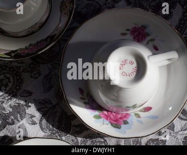 Teacup upside down on a saucer on a patterned tablecloth Stock Photo ...