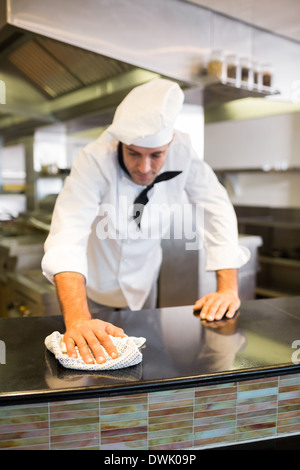 male cook wiping the counter top in the kitchen Stock Photo - Alamy