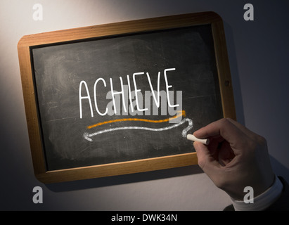 Hand writing Achieve on chalkboard Stock Photo - Alamy