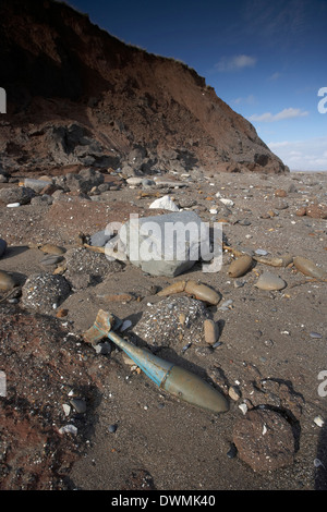 Unexploded bomb munitions exposed by coastal erosion on Mappleton beach ...